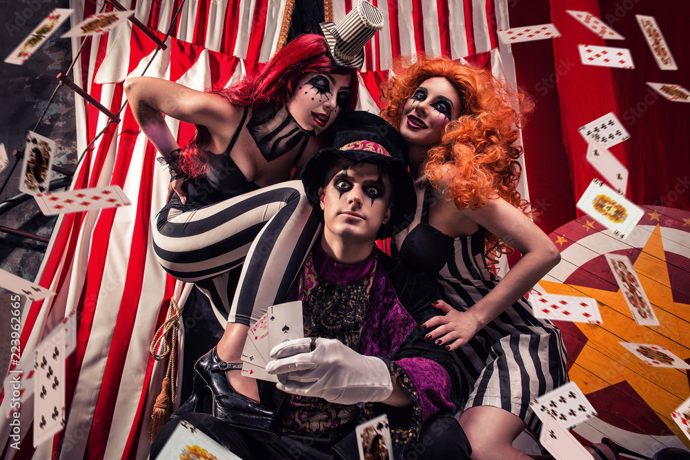Three people performing on stage freak show, showing magic tricks with ...