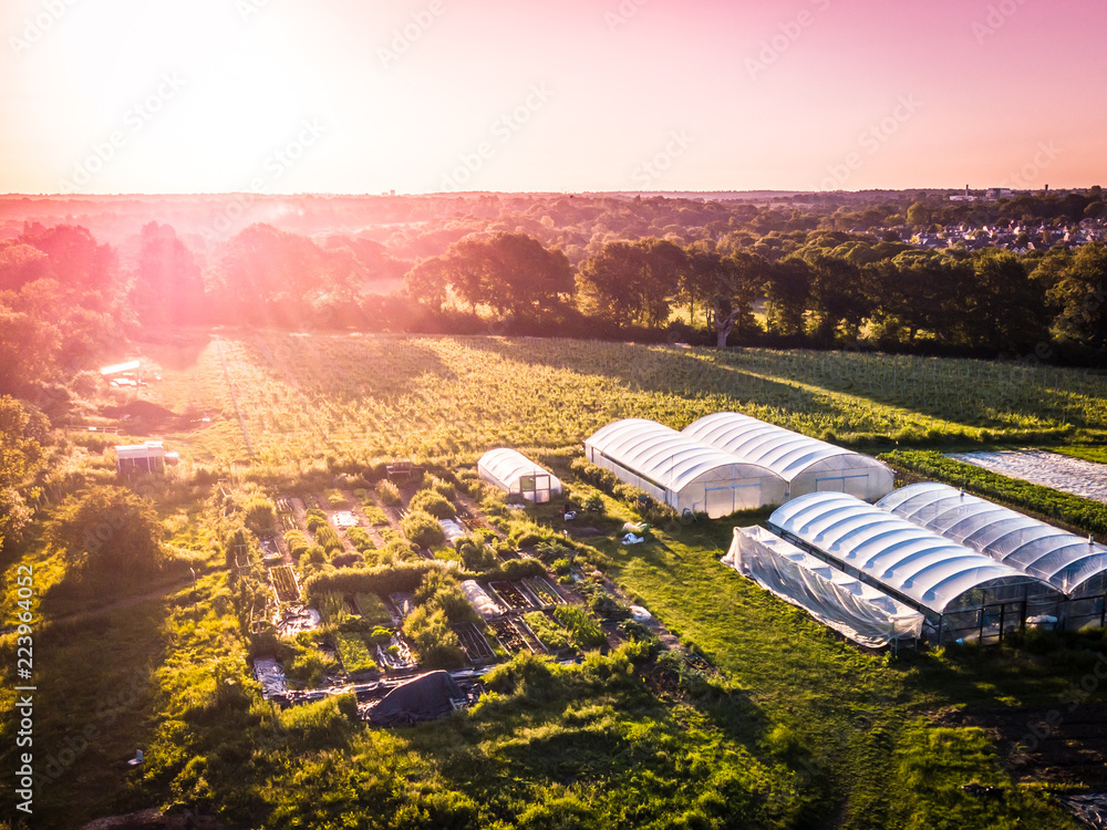 Drone aerial photography of an organic inner city farm taken at sun set ...