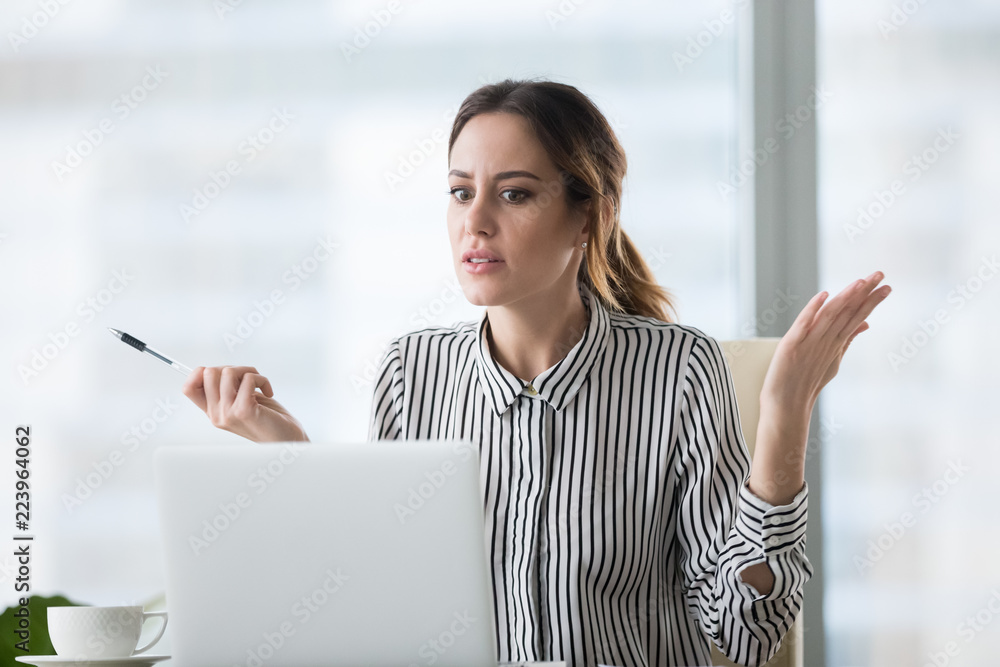 Confused businesswoman feel at loss looking at laptop screen with error ...