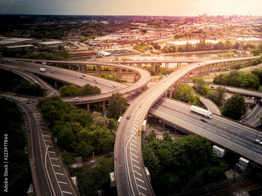 Aerial view of a complex motorway road junction with traffic moving ...