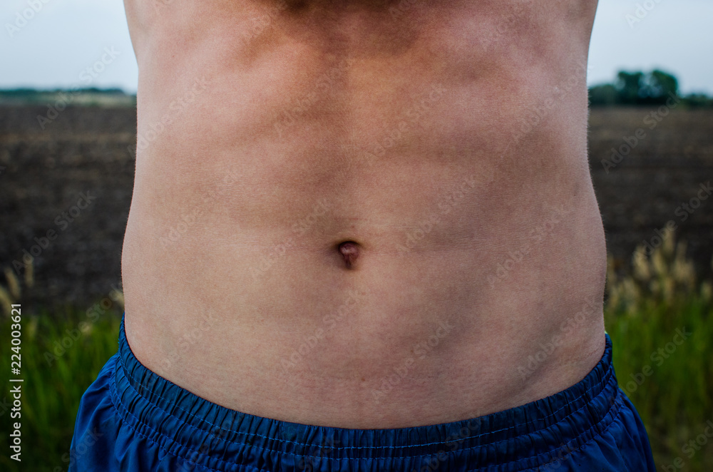 The guy shows the press on his stomach. Yoga in nature Stock Photo ...