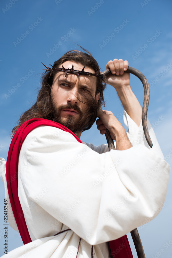 portrait of Jesus in robe, red sash and crown of thorns leaning on ...