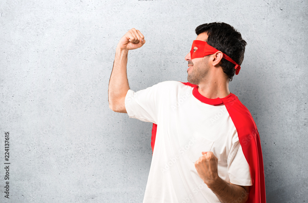 Superhero man with mask and red cape celebrating a victory in winner ...