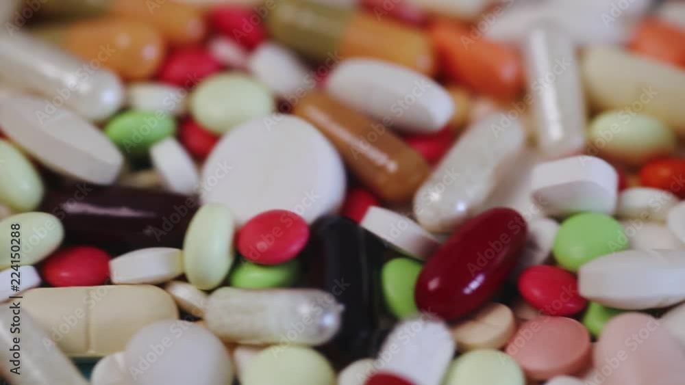 Pan view focusing in on a pile of colorful medication Stock Video ...
