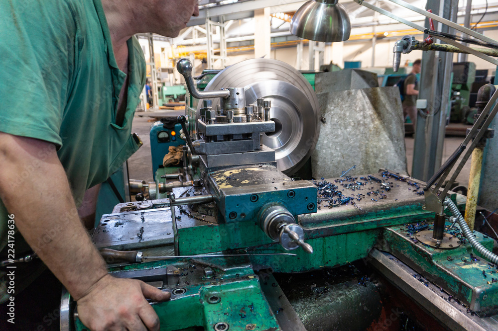 The worker, the man, makes mechanical actions of the machine control ...