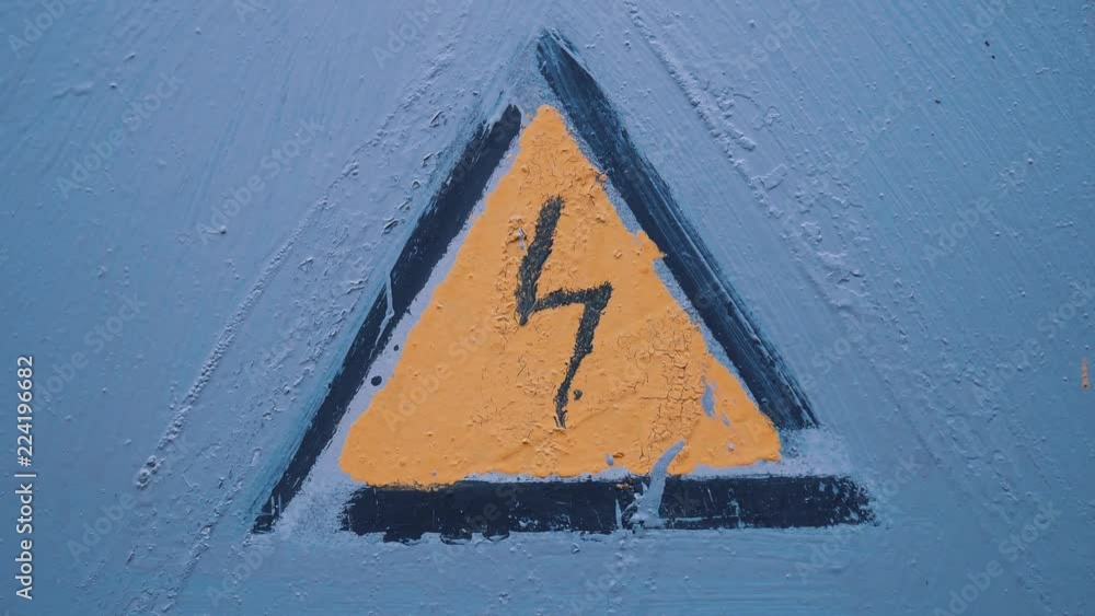 danger electricity sign. Grungy high voltage sign over blue wall ...