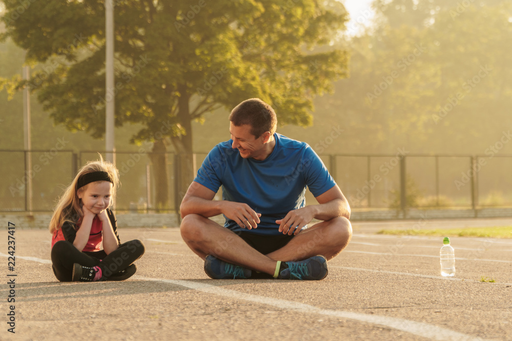 Dad and daughter go in for sports.Dad and daughter at the stadium ...