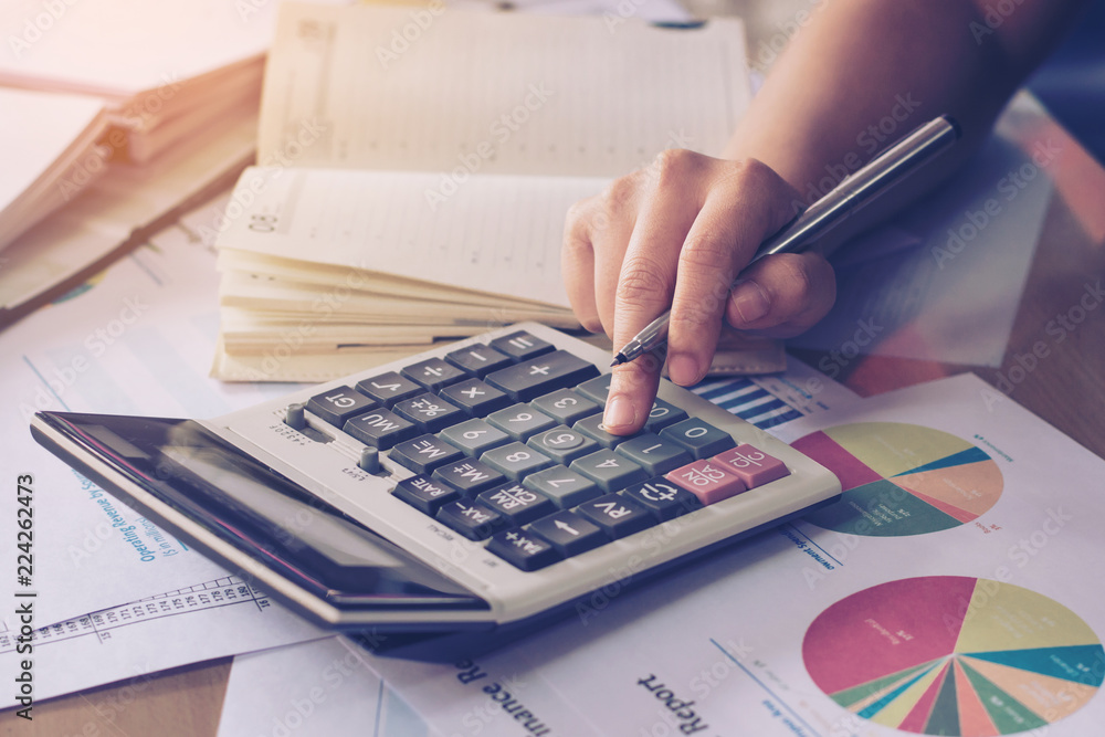 Business concep : close up woman hand using calculator and writing make ...