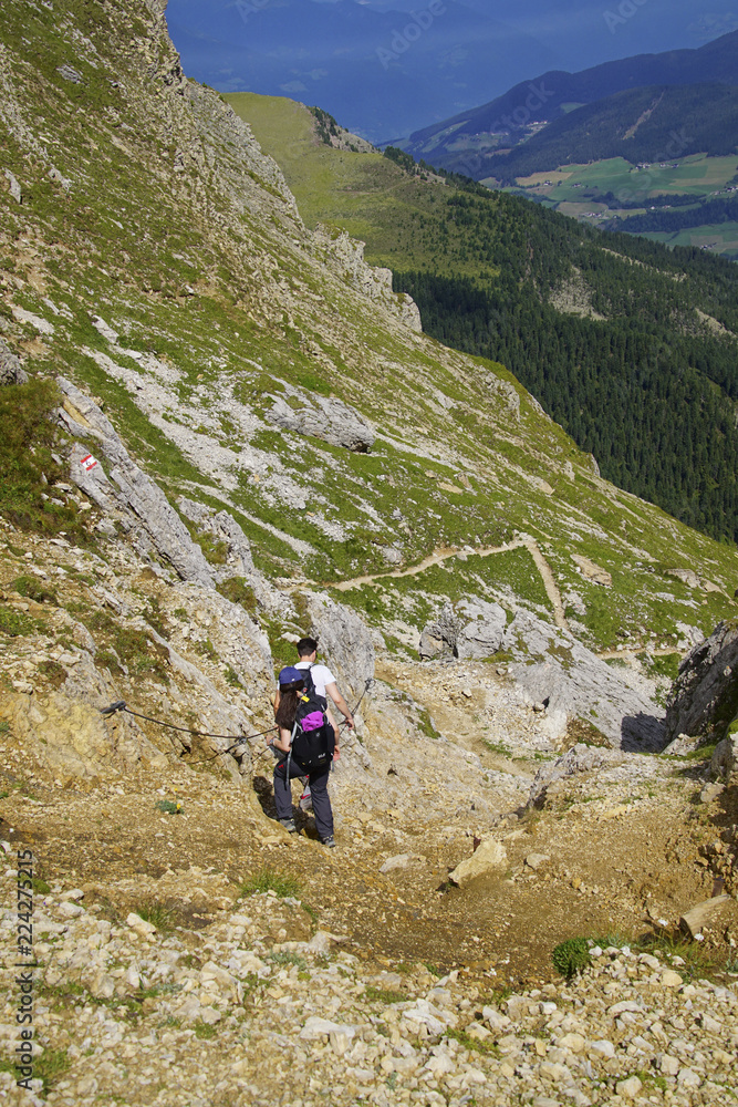Hikers descend a steep gully from a pass Stock Photo | Adobe Stock