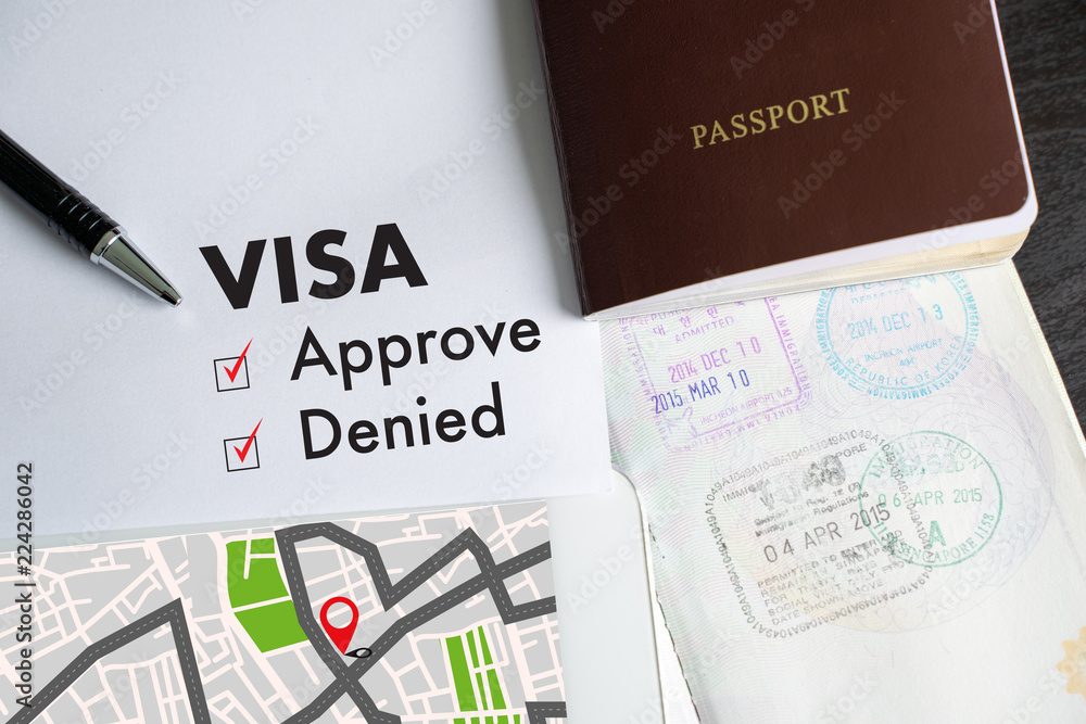 Visa and passport to approved stamped on a document top view in ...