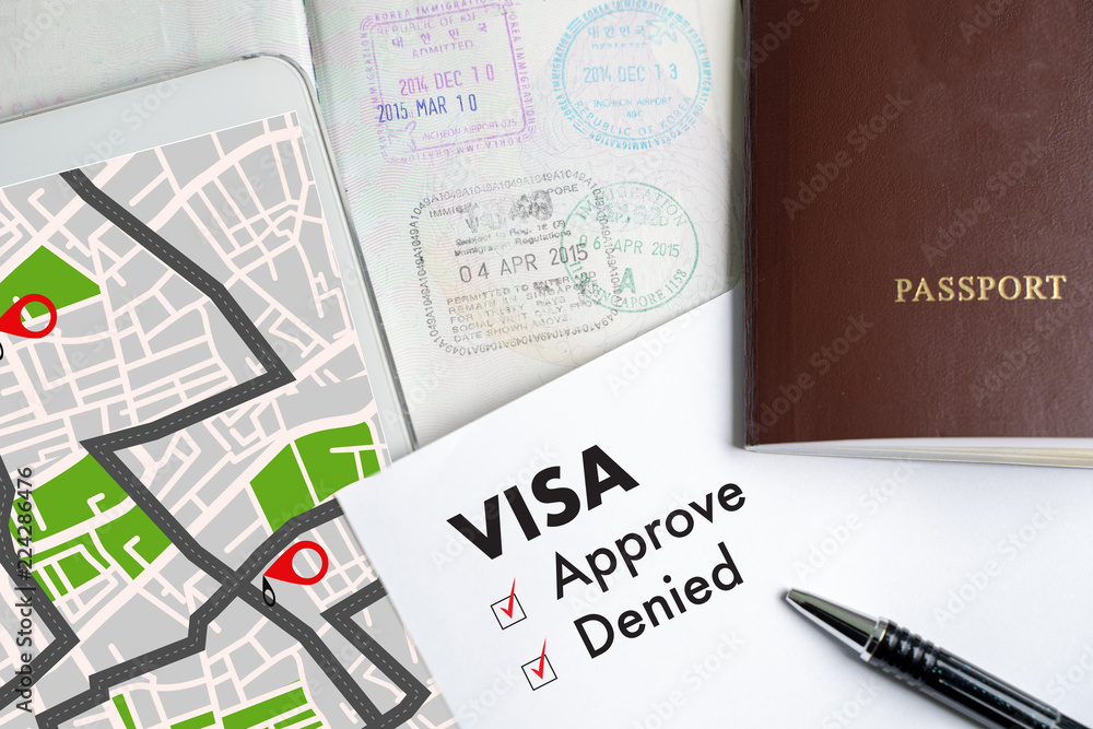 Visa and passport to approved stamped on a document top view in ...