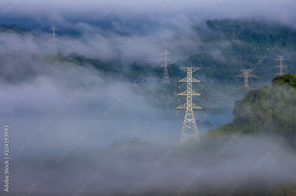 Electric transmission towers in fog Stock Photo | Adobe Stock