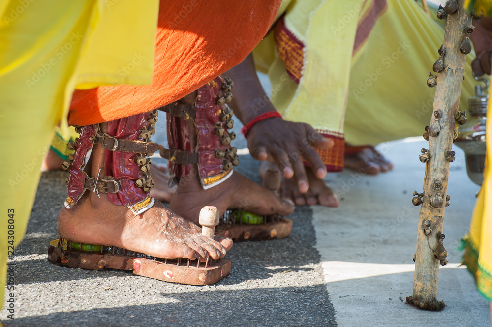 Thaipusam devotee in Penang wearing spiky shoes in penance Stock Photo ...