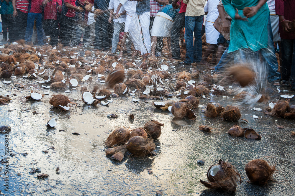 People along roadside smashing coconuts to welcome Hindu god during ...