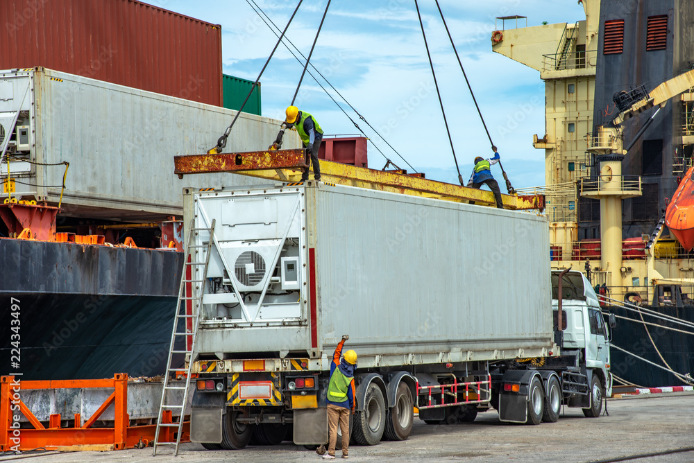 container unit being lift loading by the ship crane from the trailer to ...
