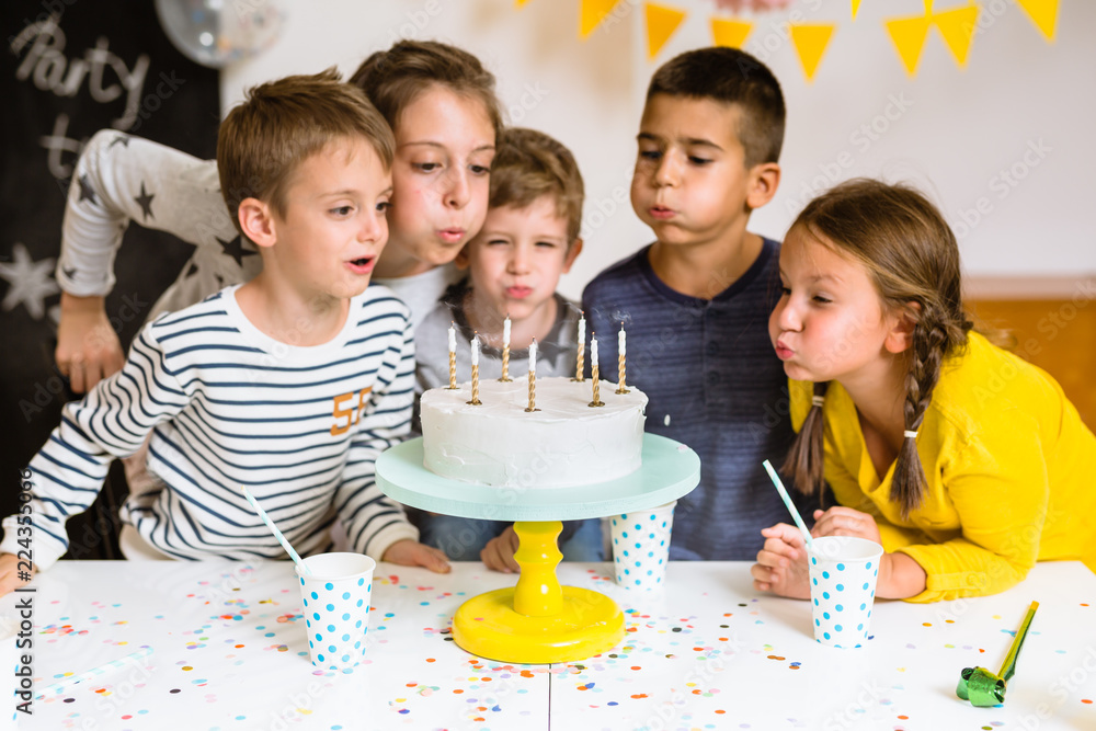 Child Blowing Out Candles