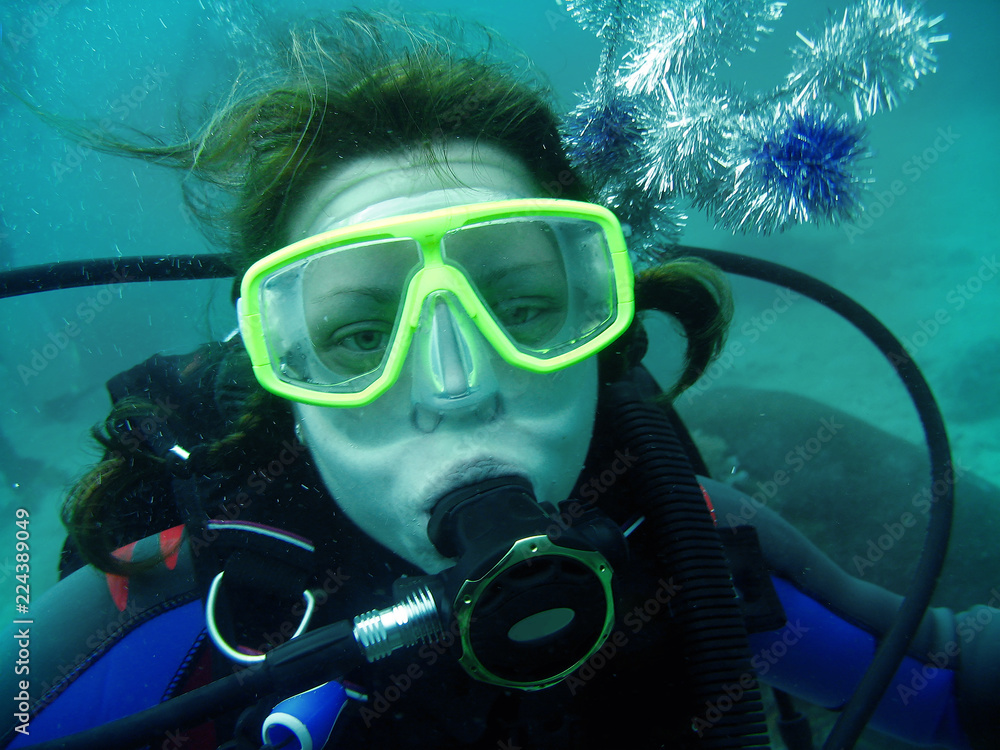 The portrait of young woman with scuba diving equipment: mask ...