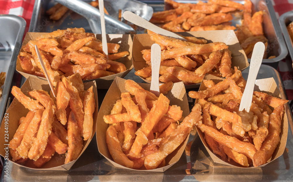 Papaer dishes, coasters with portions of sweet potato chips, batatas ...