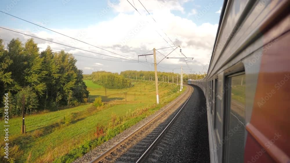 Railroad cars outside train ride on rails near the forest railway. slow ...