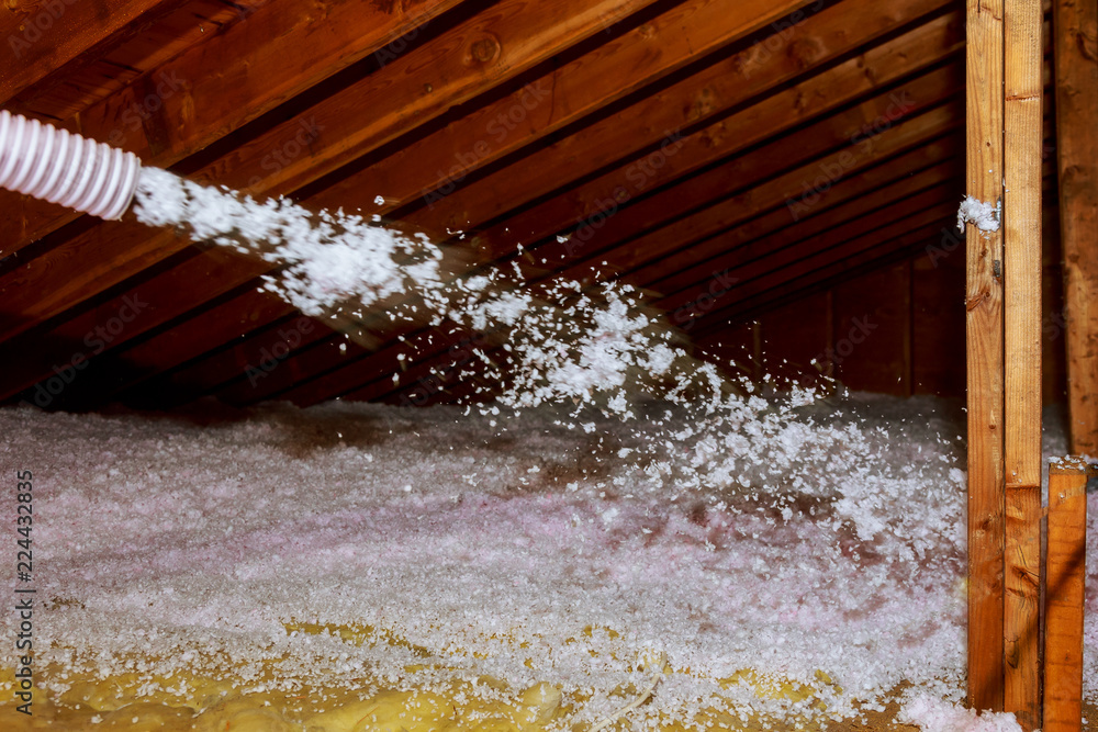 Worker Spraying mineral rock wool of house attic insulation Stock Photo ...
