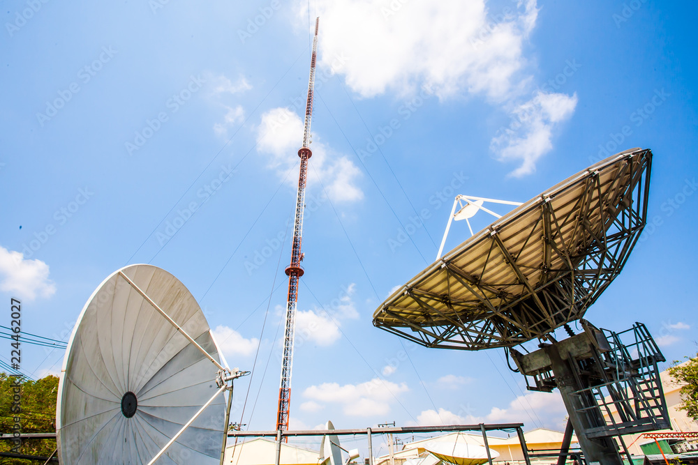 Signal Tower and satellite dish The sky is big and the clouds are white ...
