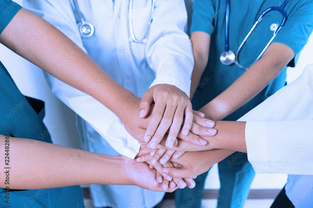 Stockfoto Doctors and nurses coordinate stacking hands together at hospital, Concept Teamwork ...