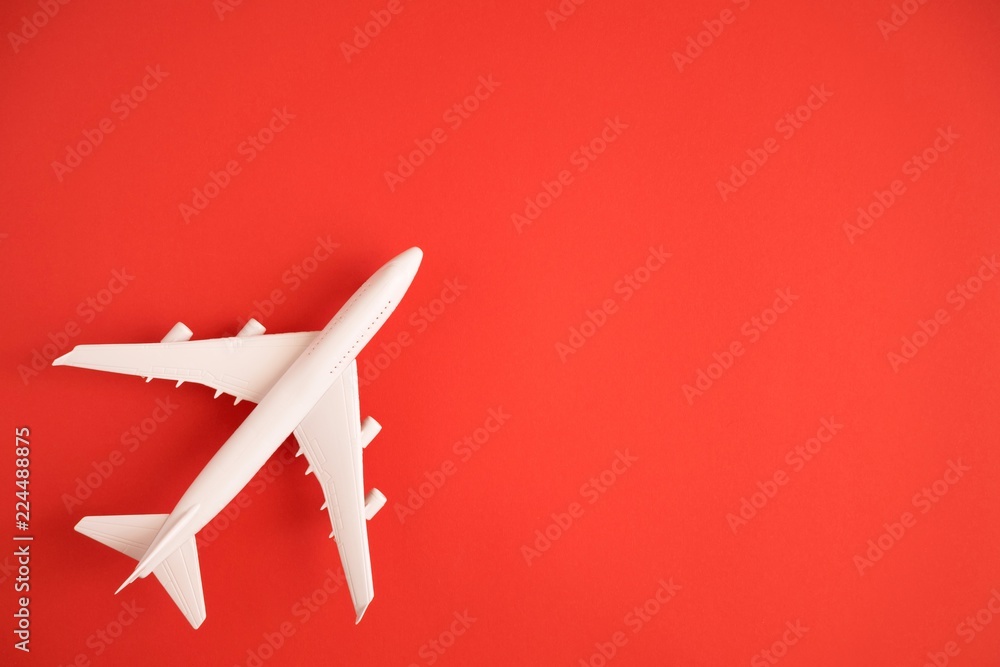 Airplane model. White plane on red background. Stock Photo | Adobe Stock