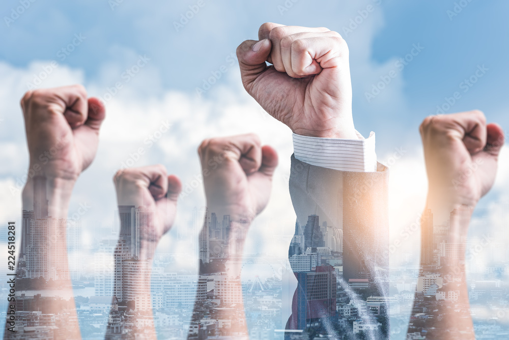 the double exposure image of the hands rising up to the sky overlay ...