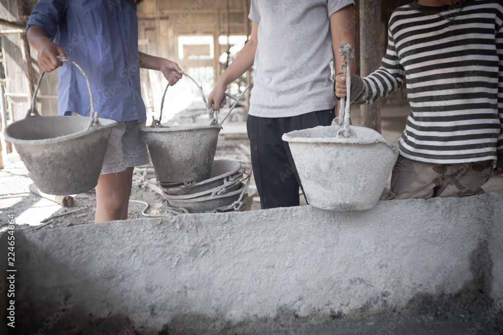 Little girl and boys labor working in commercial building structure ...