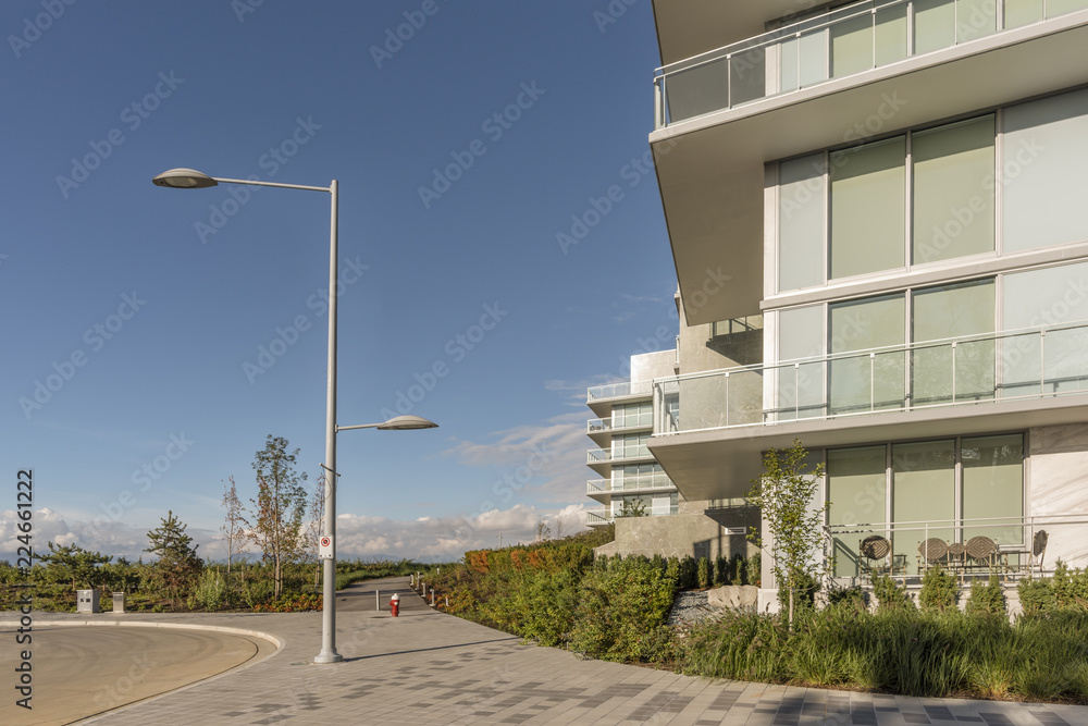 modern, new high-rise residential building, a table and wicker chairs ...