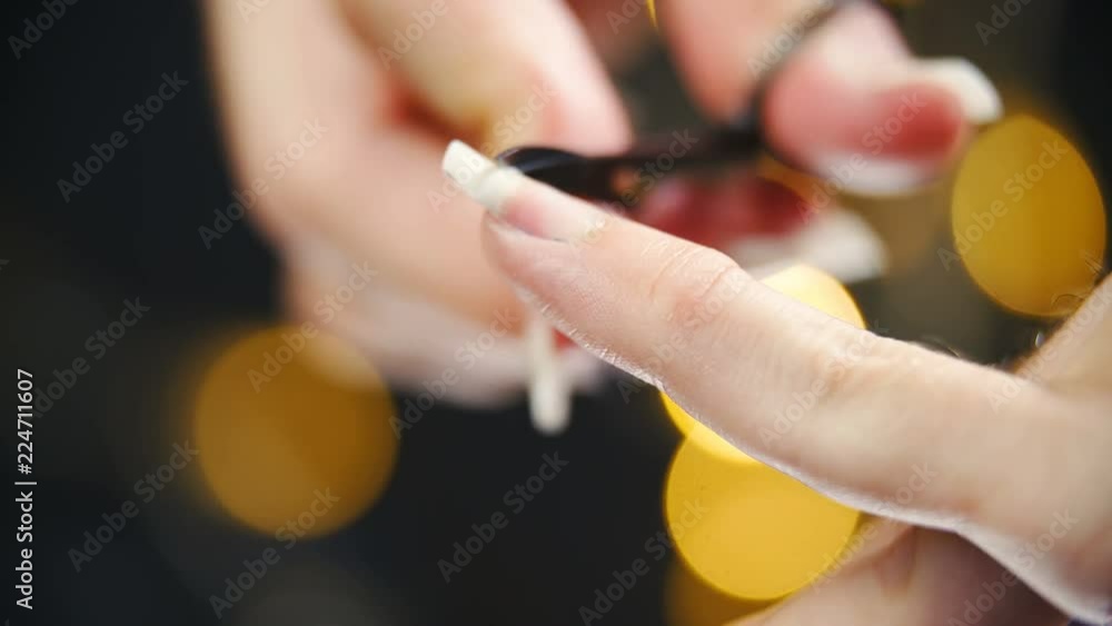 Slowly cut the long fingernail with scissors close-up 4K. Long shot of ...