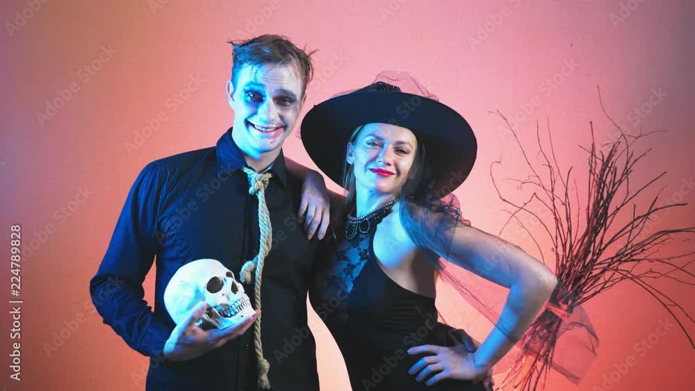 a beautiful couple, a man and a woman in witch and zombie costumes for ...