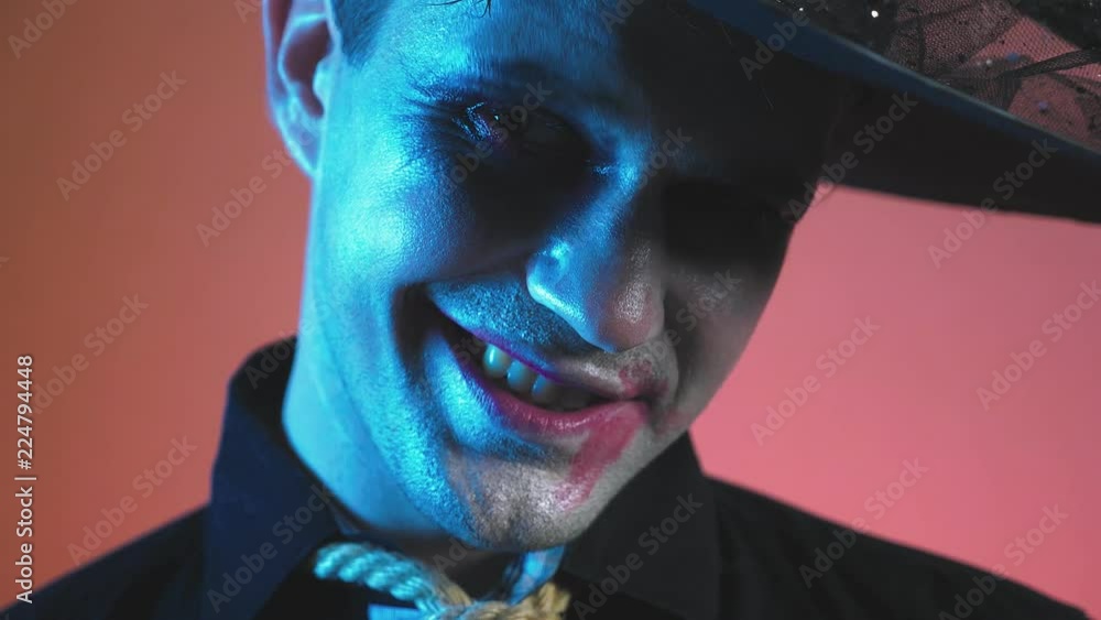 a young man in a zombie halloween costume, look at the camera and ...