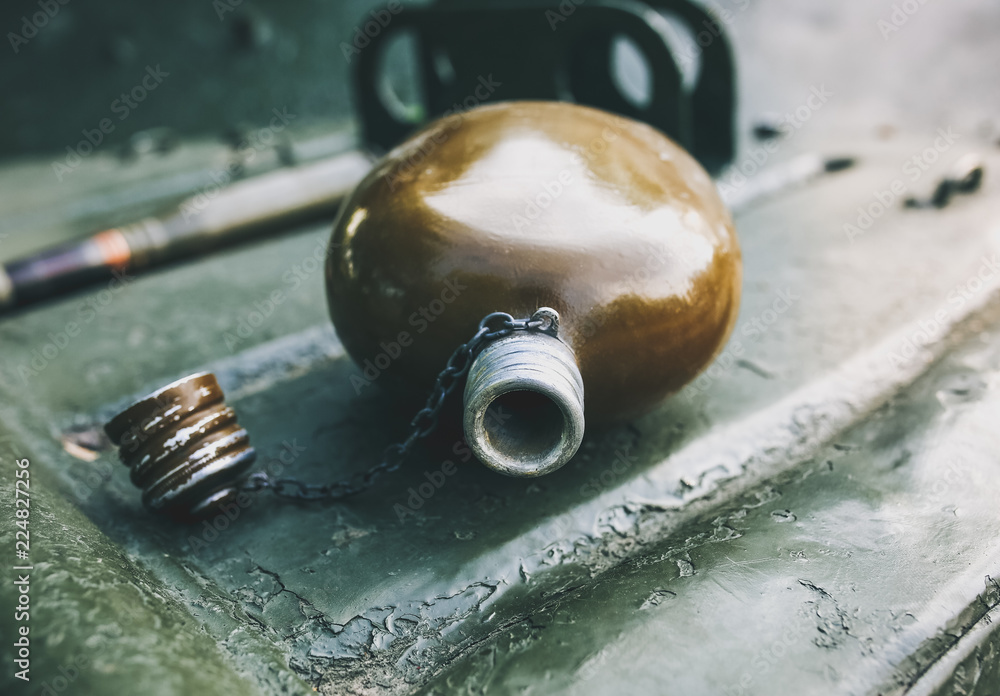 War flask with shell missile is lying on the old khaki peeling paint of ...