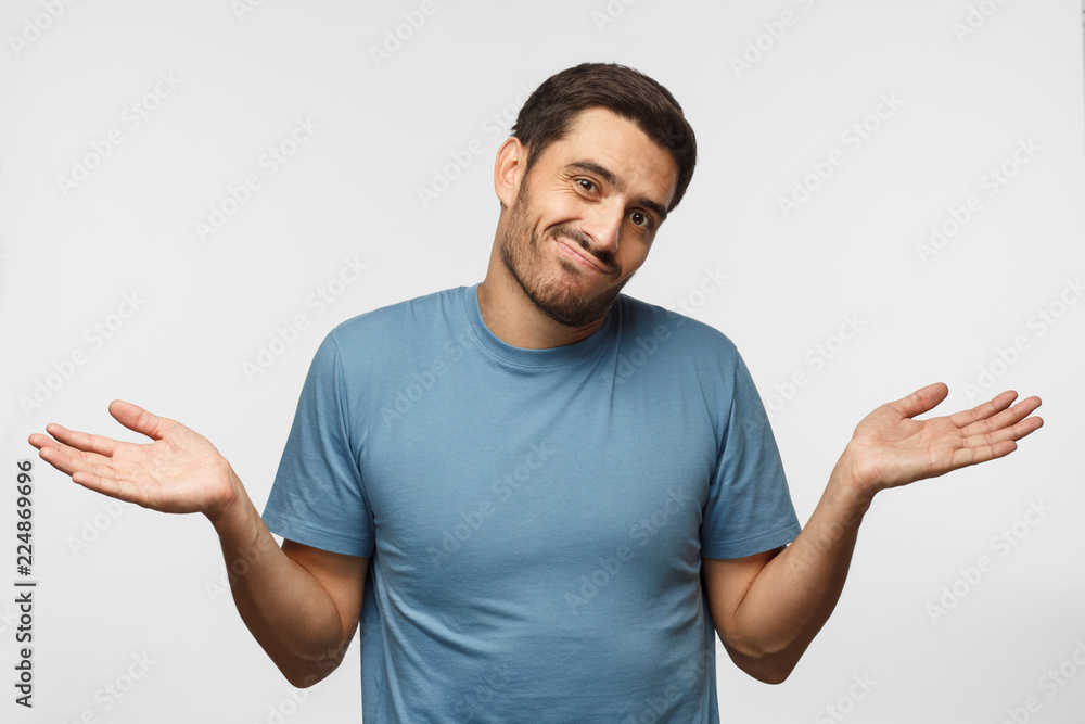 Fotografia do Stock: I don't know. Young man isolated on gray ... Fotografia do Stock: I don't know. Young man isolated on gray ...