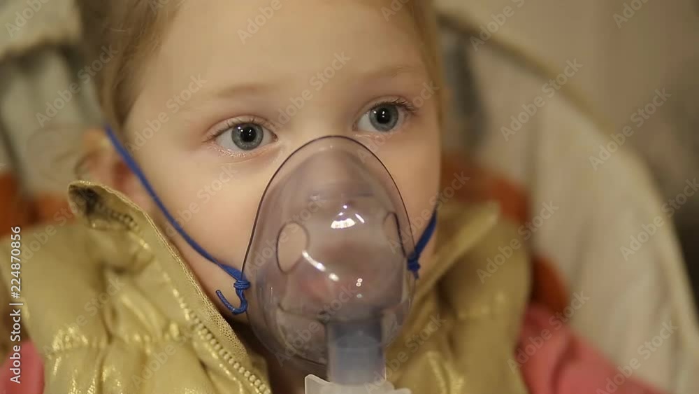 Inhalation mask on child face. Little girl doing inhalation at hospital ...
