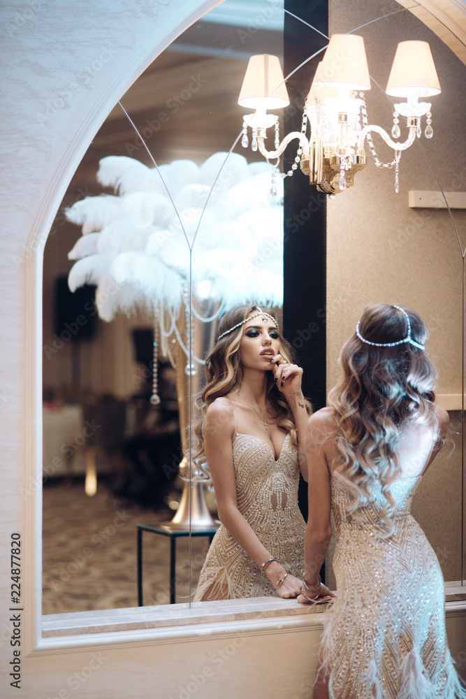 Sensual woman enjoy her look in mirror. Pretty girl with glamorous look ...