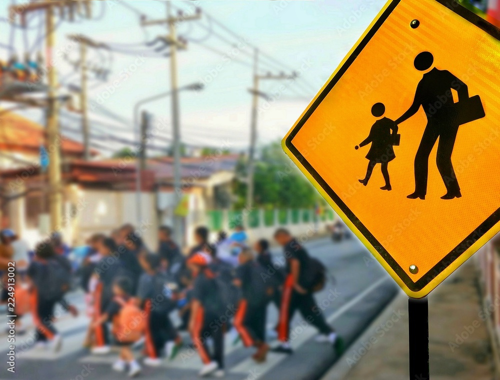 Focus on traffic security school sign with blur many students are ...