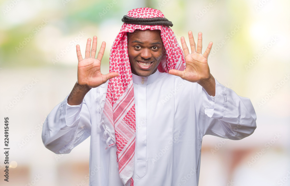 Young arabic african man wearing traditional keffiyeh over isolated ...