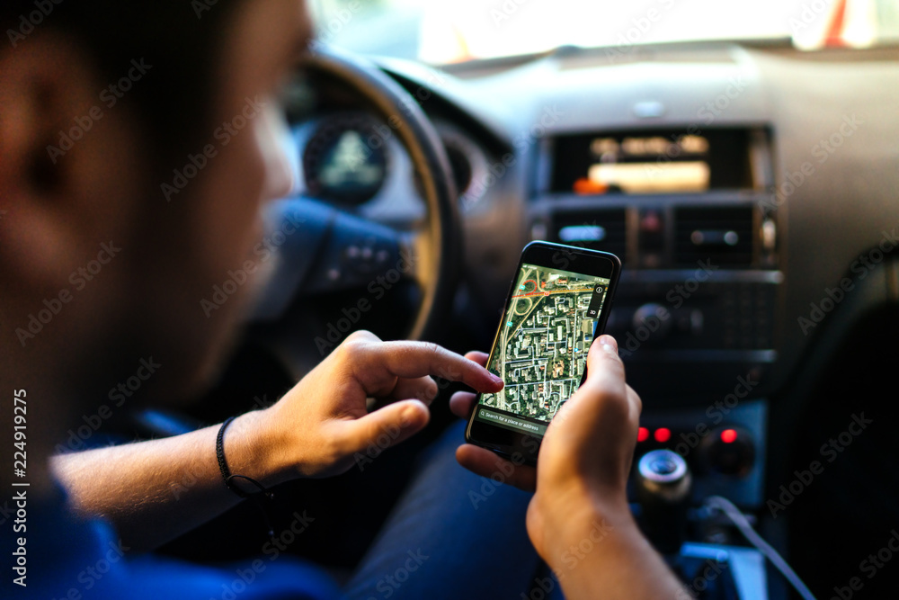 Driver using gps navigation system, online maps and smartphone for ...