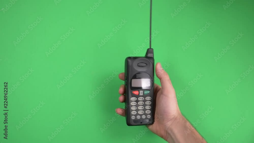 Vintage 80s 90s cell phone with antenna on green screen chroma key ...