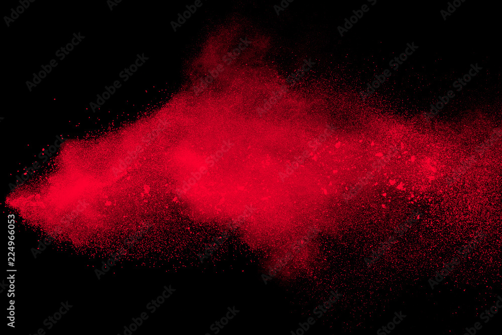 Red color powder explosion on black background.Freeze motion of red ...