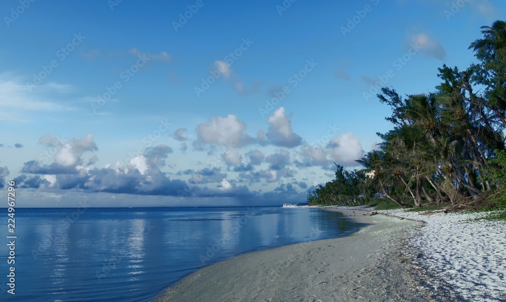 Beautiful beach with white fluffy cottony clouds in Garapan, Saipan ...