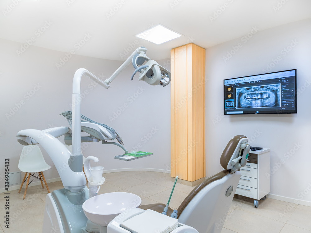 Clean white modern dentist cabinet. Spacious room with a dental ...