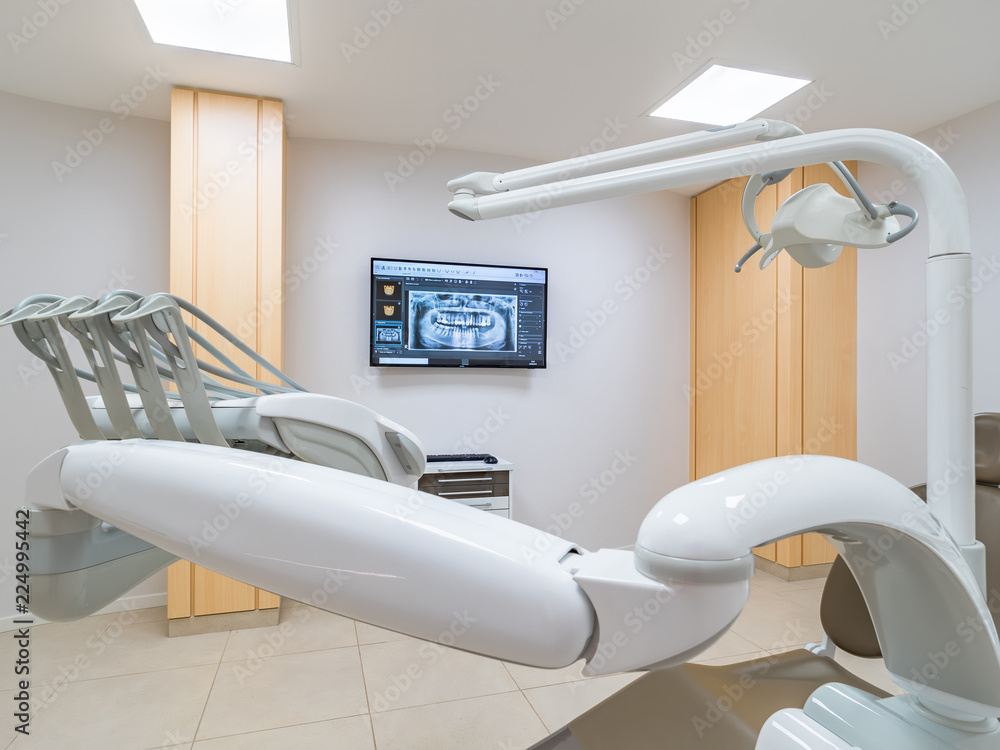 Clean white modern dentist cabinet. Spacious room with a dental ...