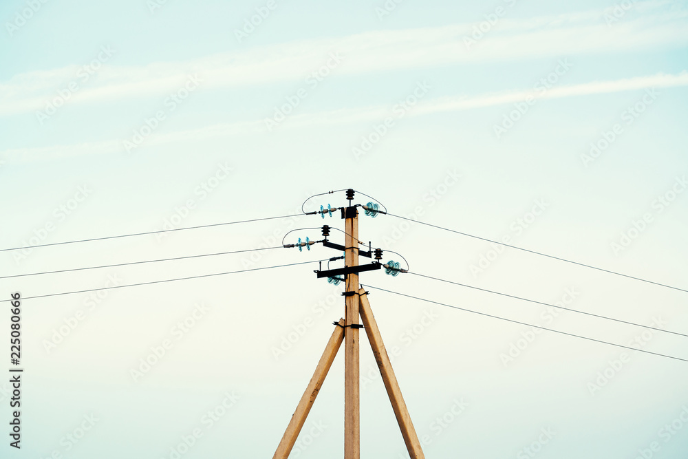 Power lines on background of blue sky close-up. Electric hub on pole ...