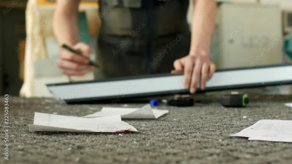 Production and manufacturing of pvc windows, the worker marks the size ...