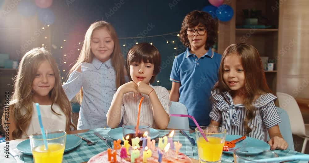 Children having birthday party, blowing out the candles on birthday ...