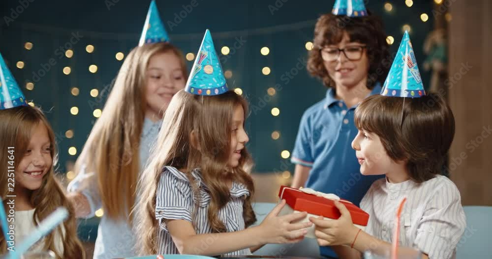 Children celebrating birthday party, excitedly waiting to blow out the ...