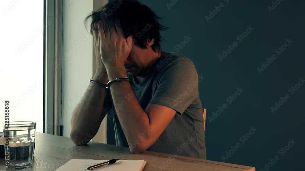 Desperate criminal in interrogation room during police interview with ...